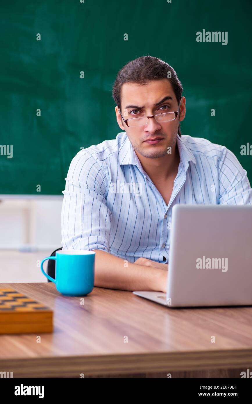 Young teacher in tele-education concept in the classroom Stock Photo ...
