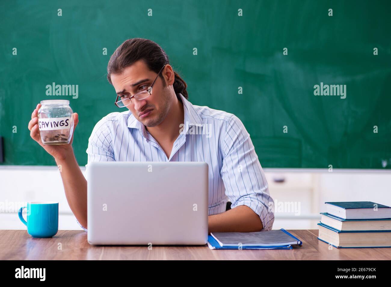 Young teacher in remuneration concept Stock Photo - Alamy