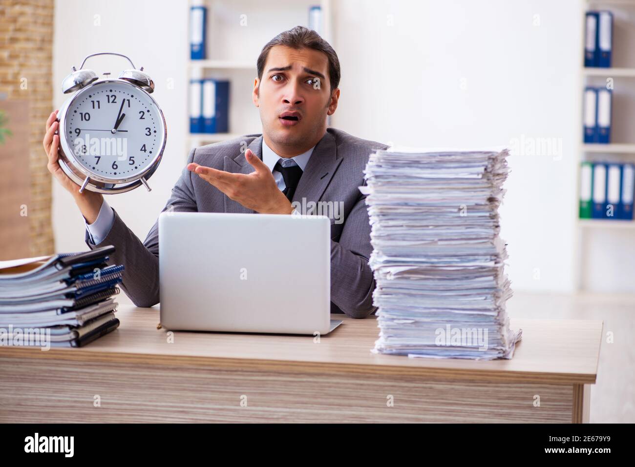 Workload employee in time management concept Stock Photo - Alamy