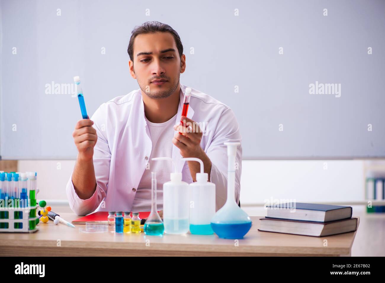 Young chemistry teacher in the classroom Stock Photo - Alamy