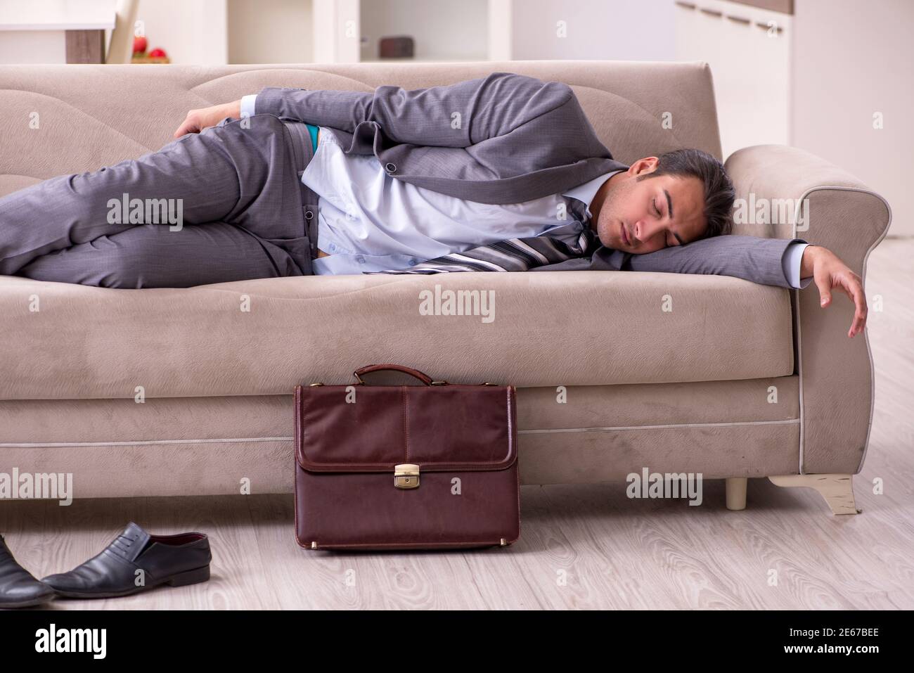 Businessman coming home tired hi-res stock photography and images - Alamy