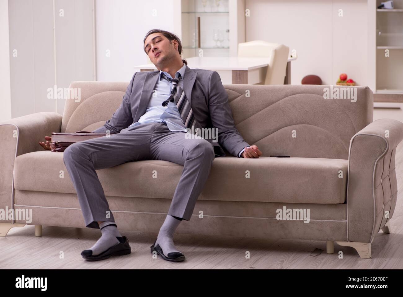 Businessman coming home tired hi-res stock photography and images - Alamy