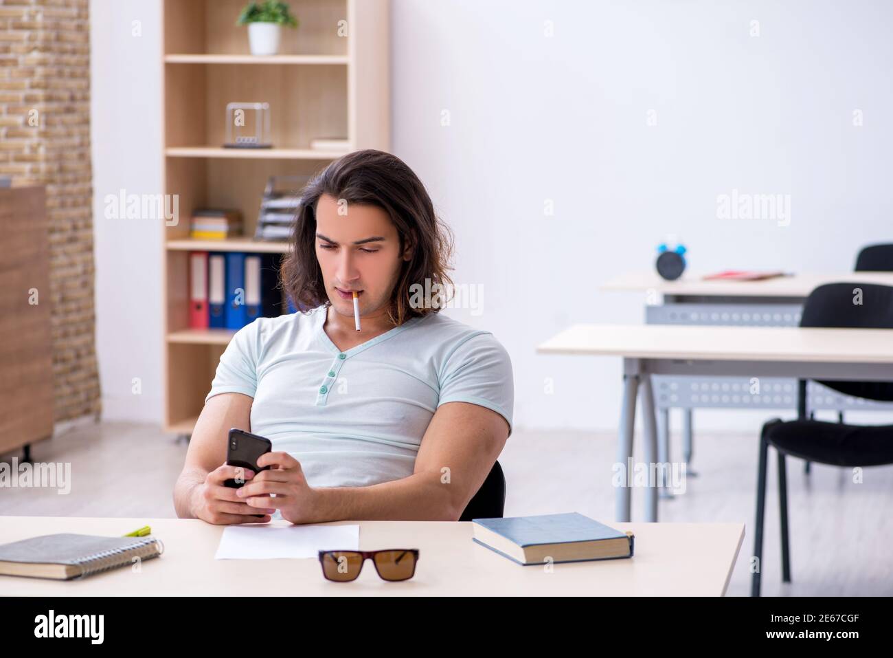Male student smoking cigarettes in the classroom Stock Photo - Alamy