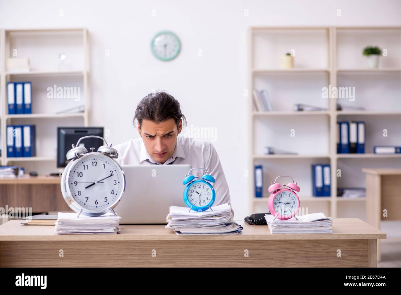 Young employee afraid of missing deadline at workplace Stock Photo - Alamy