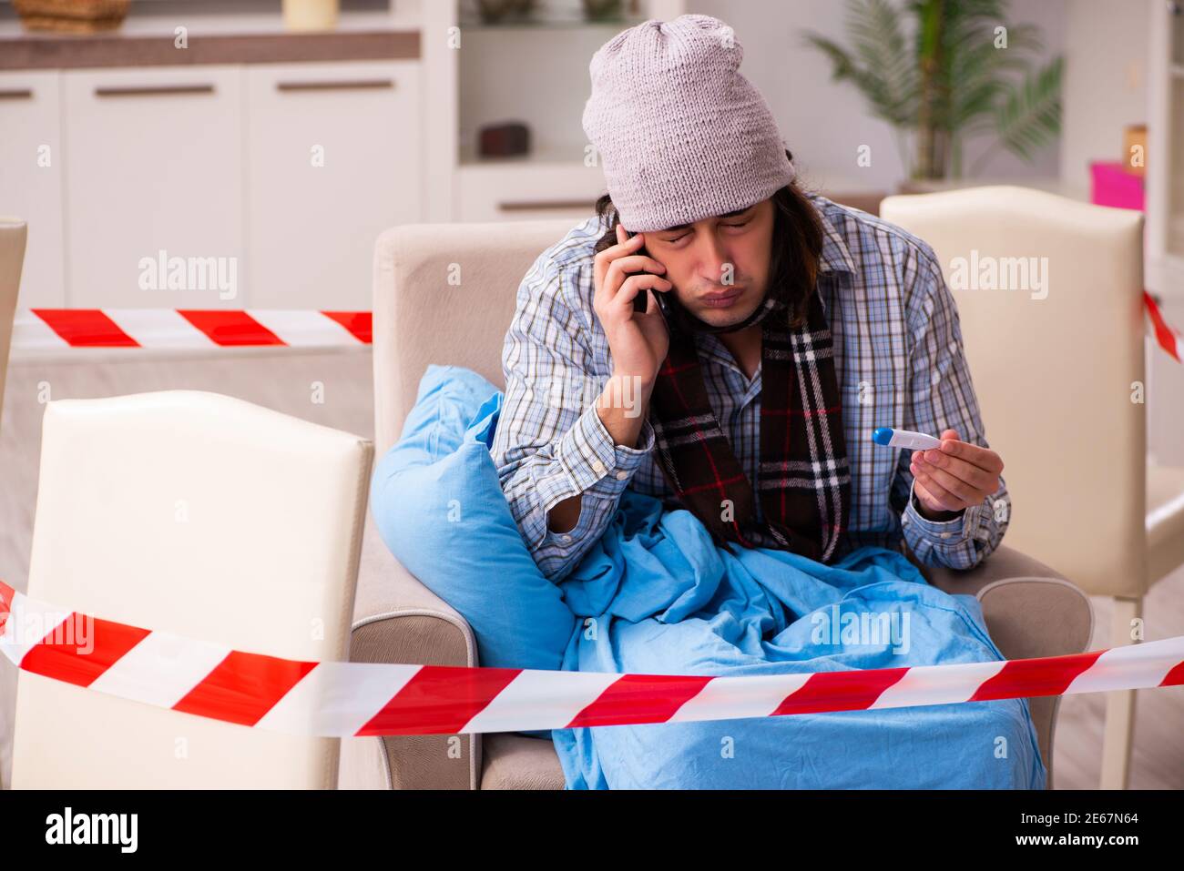 Sick man measuring temperature at home during pandemic Stock Photo - Alamy