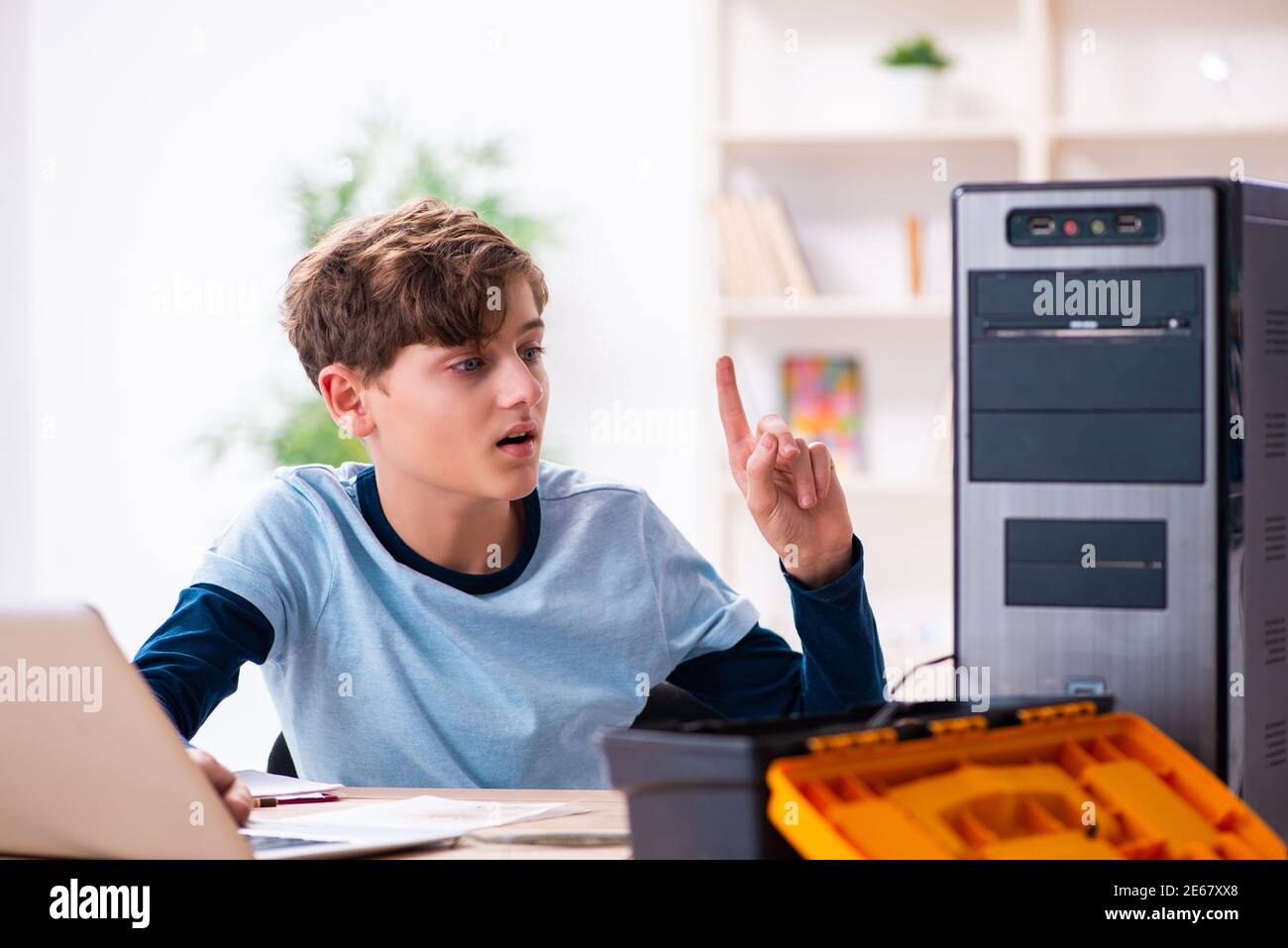 Teenager reparing computers at workshop Stock Photo - Alamy