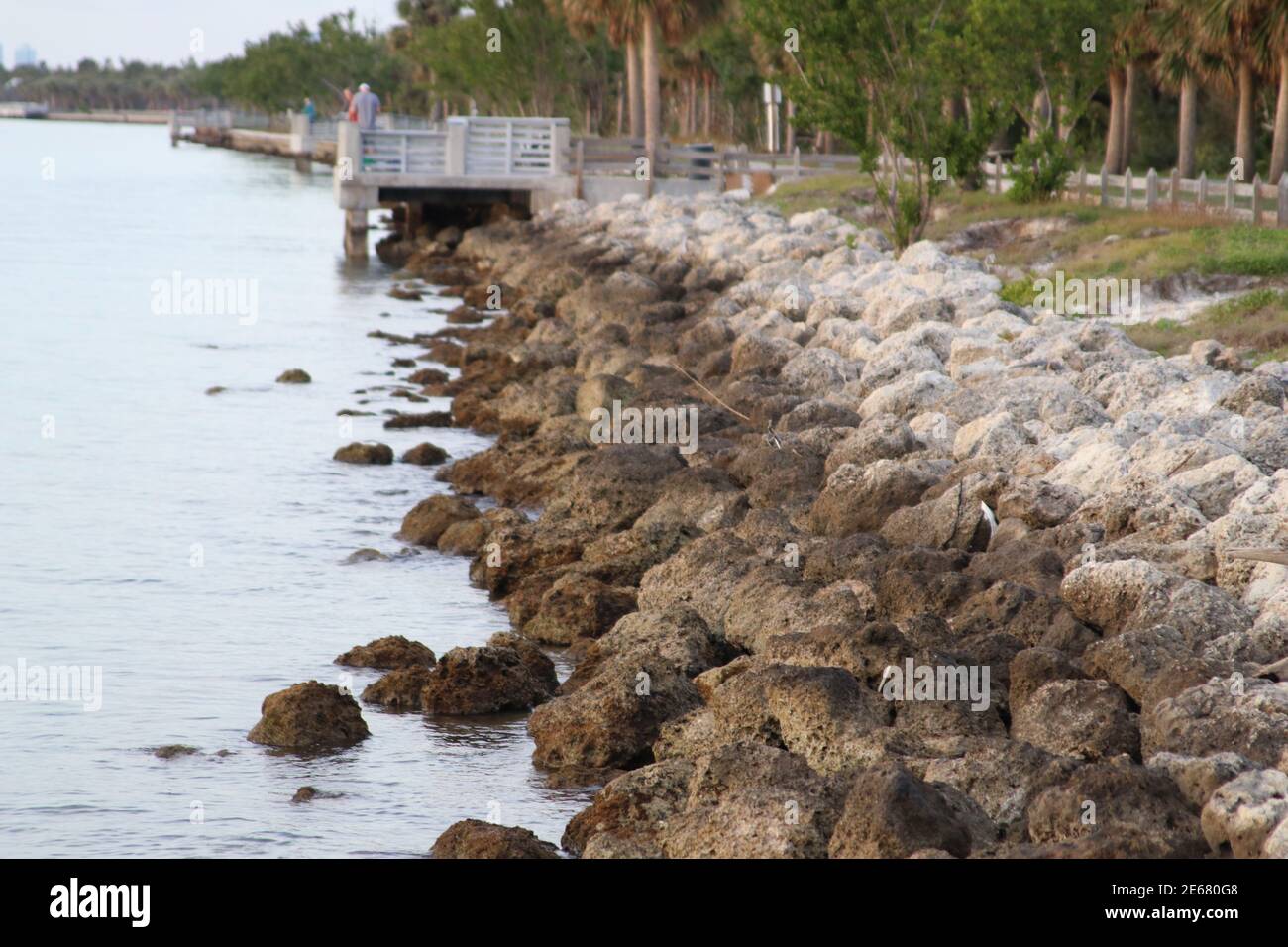 Rocks at sea shore, walkway and piers Stock Photo - Alamy