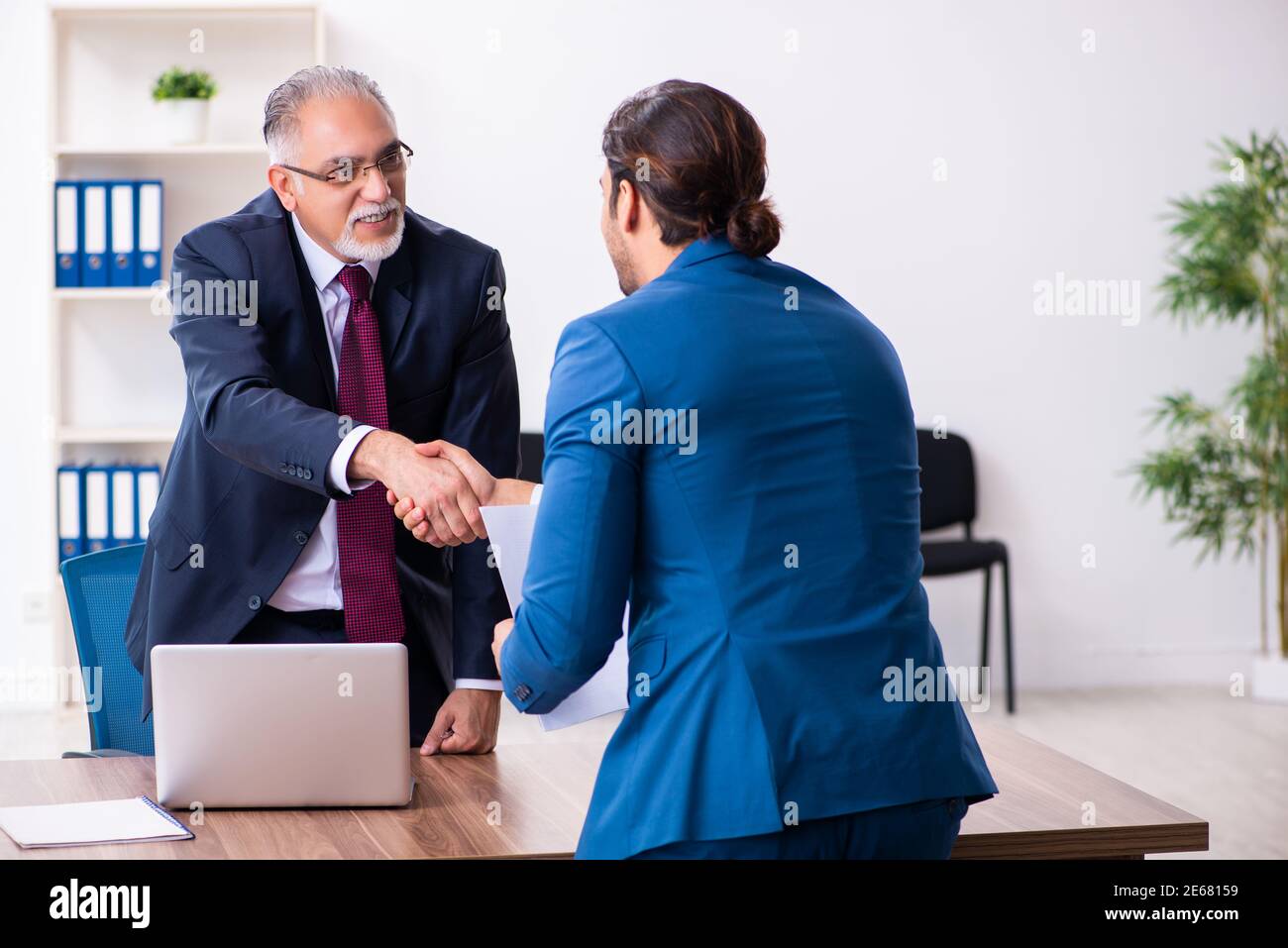 Male candidate employee meeting with old recruiter Stock Photo - Alamy