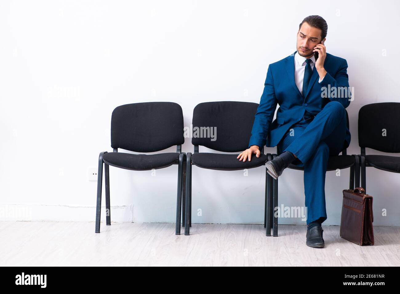 Businessman waiting for an interview at hall Stock Photo - Alamy