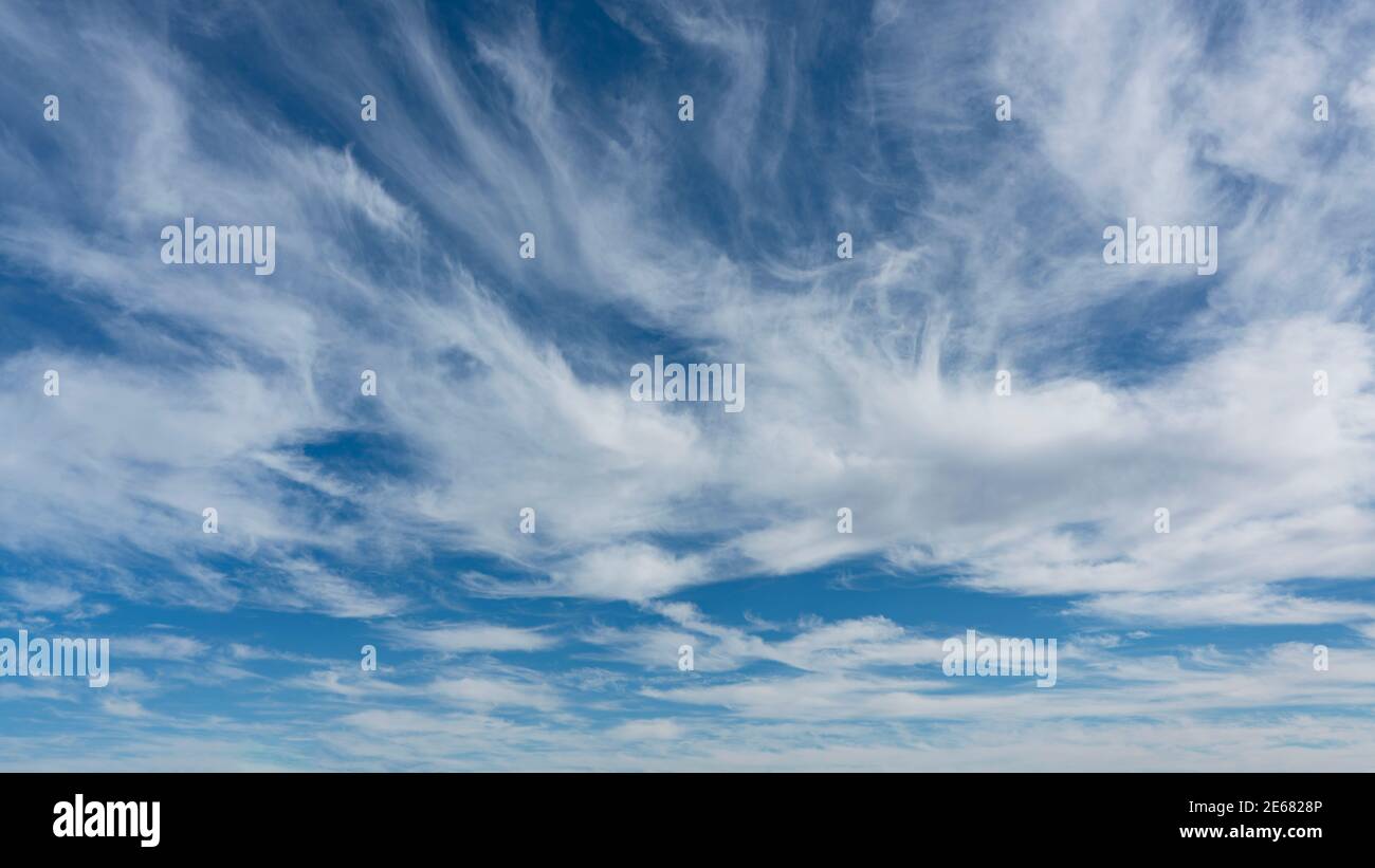 WIspy clouds and blue sky suitable for background Stock Photo - Alamy