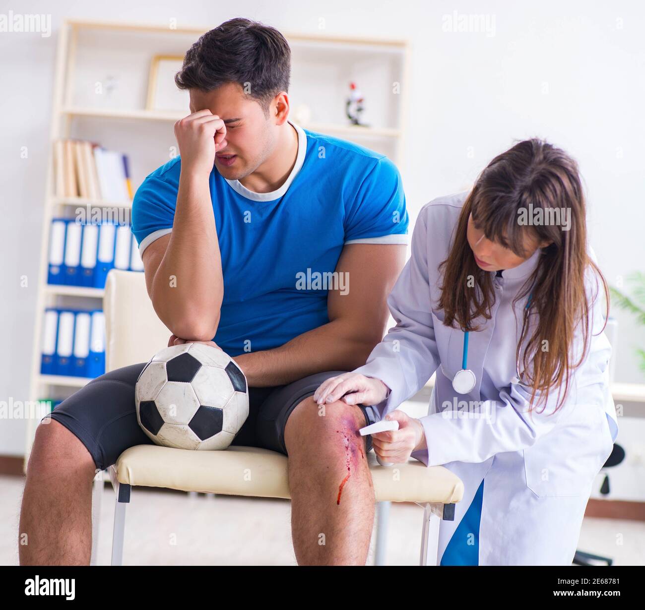 The football soccer player visiting doctor after injury Stock Photo - Alamy