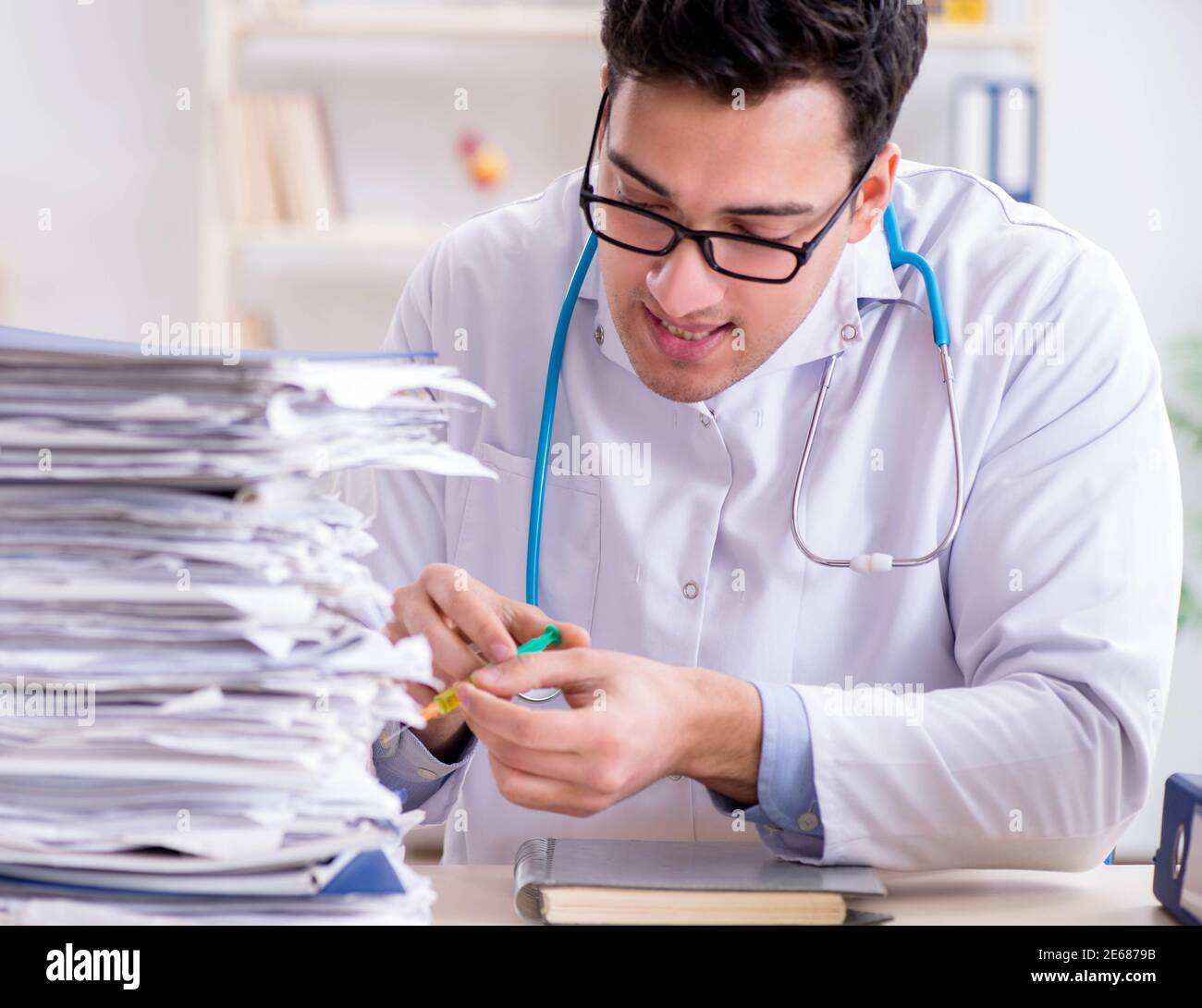 The busy doctor with too much work in hospital Stock Photo - Alamy