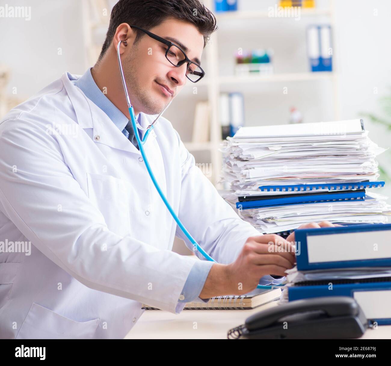 The busy doctor with too much work in hospital Stock Photo - Alamy