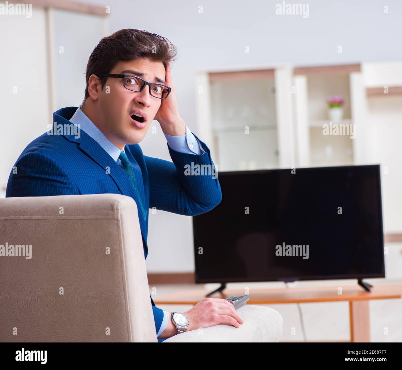 The businesman watching tv in office Stock Photo - Alamy