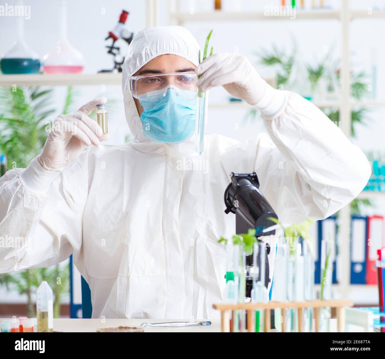 The male biochemist working in the lab on plants Stock Photo - Alamy
