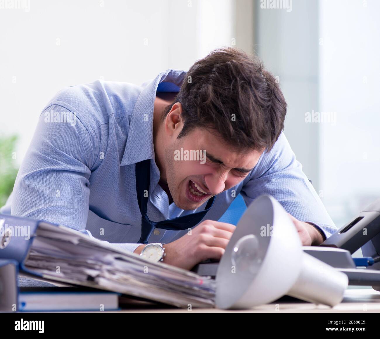 The angry businessman frustrated with too much work Stock Photo - Alamy