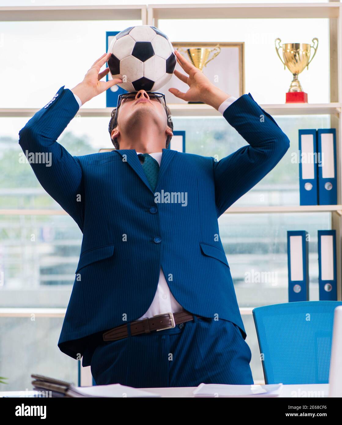 The businessman playing football in the office Stock Photo - Alamy
