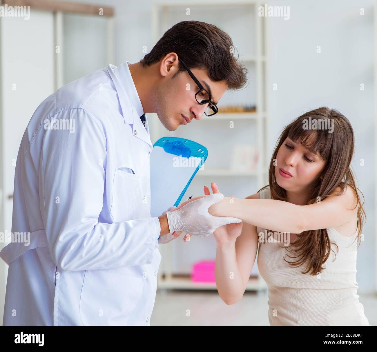 The doctor examining the skin of female patient Stock Photo - Alamy
