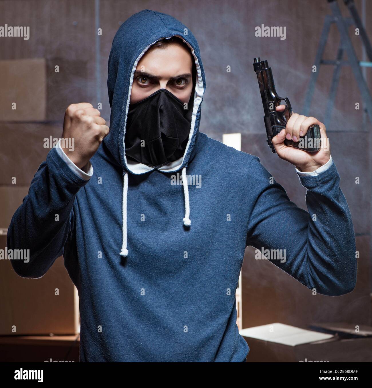 The aggressive manwith gun wearing face mask Stock Photo - Alamy