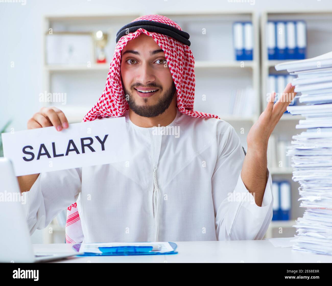The arab man sitting at desk with message Stock Photo - Alamy