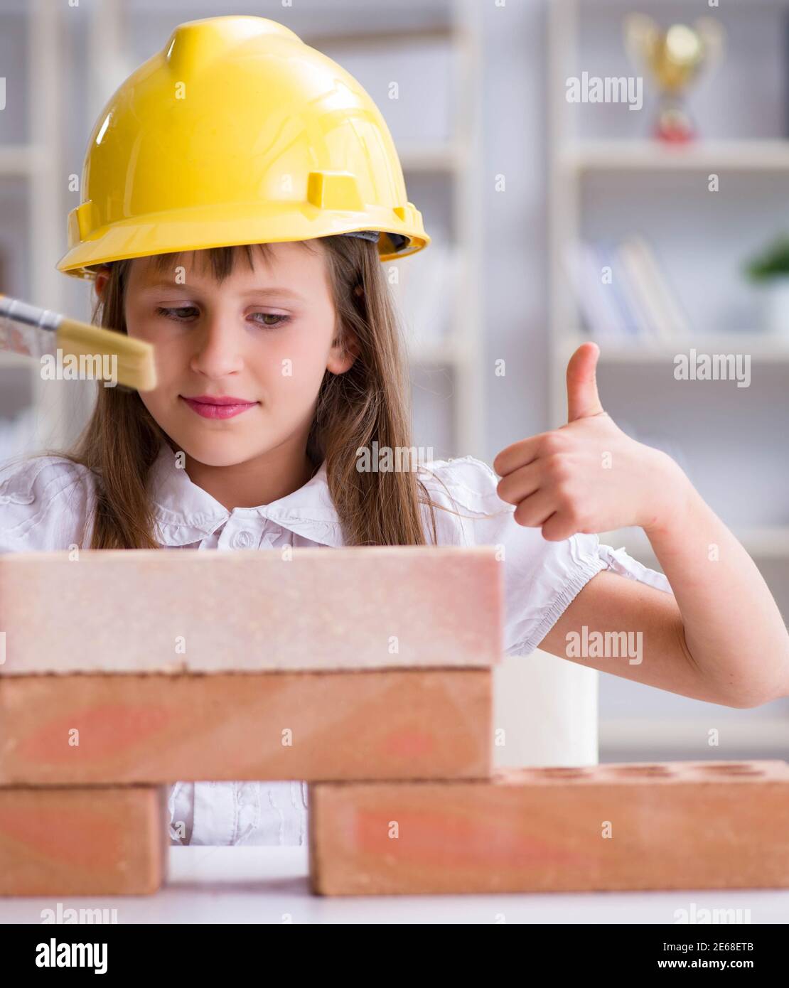 The young girl building with construction bricks Stock Photo - Alamy