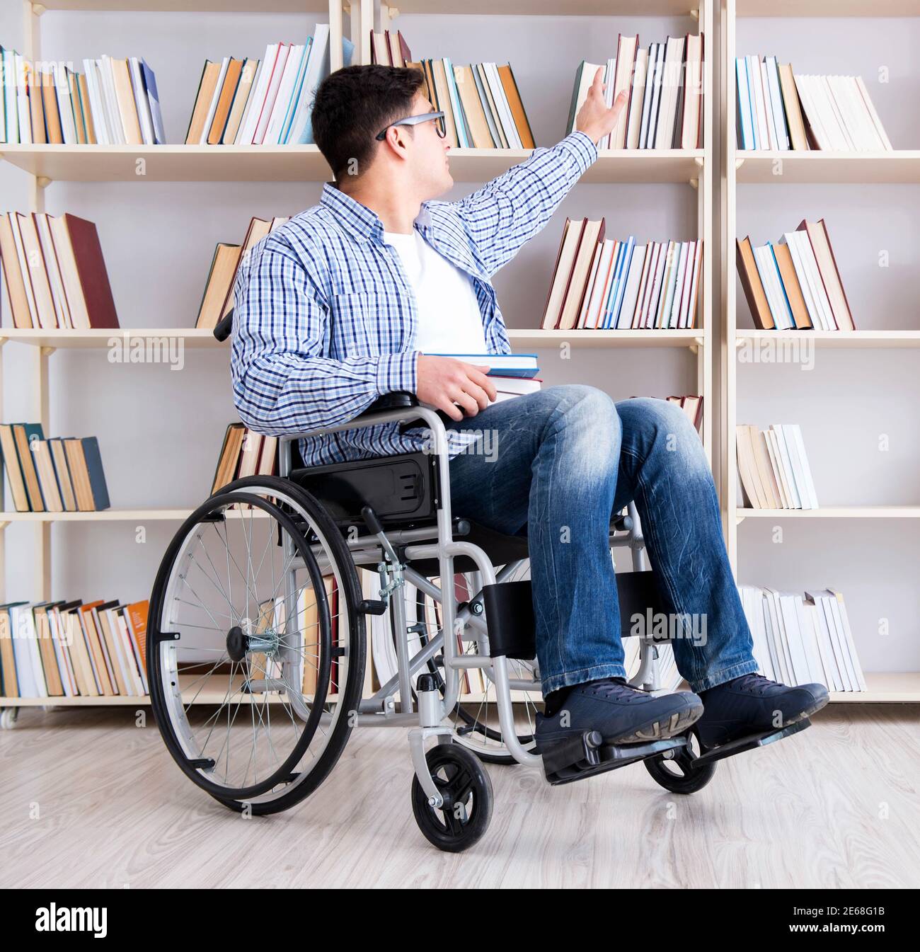 The disabled student studying in the library Stock Photo - Alamy