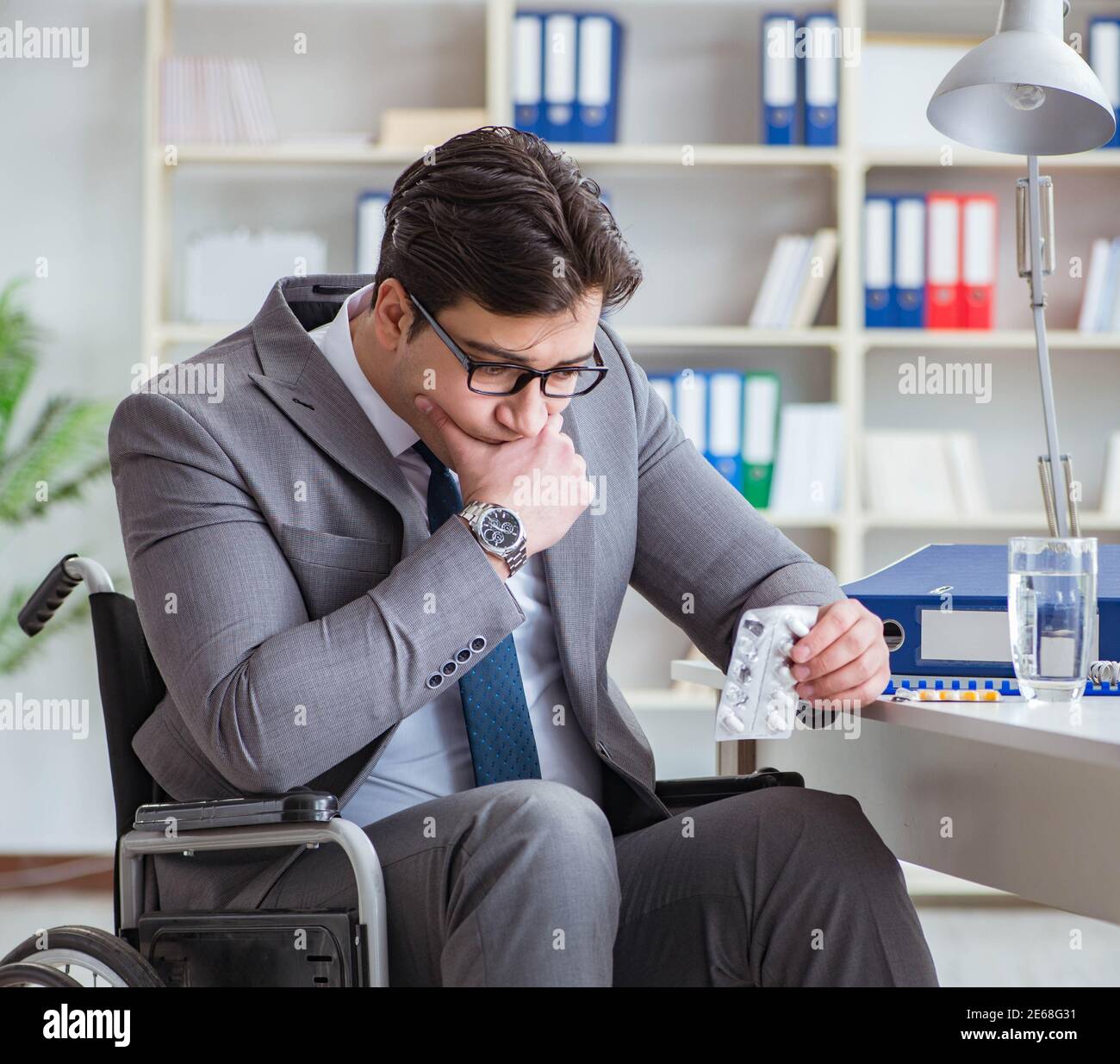 The disabled businessman working in the office Stock Photo - Alamy