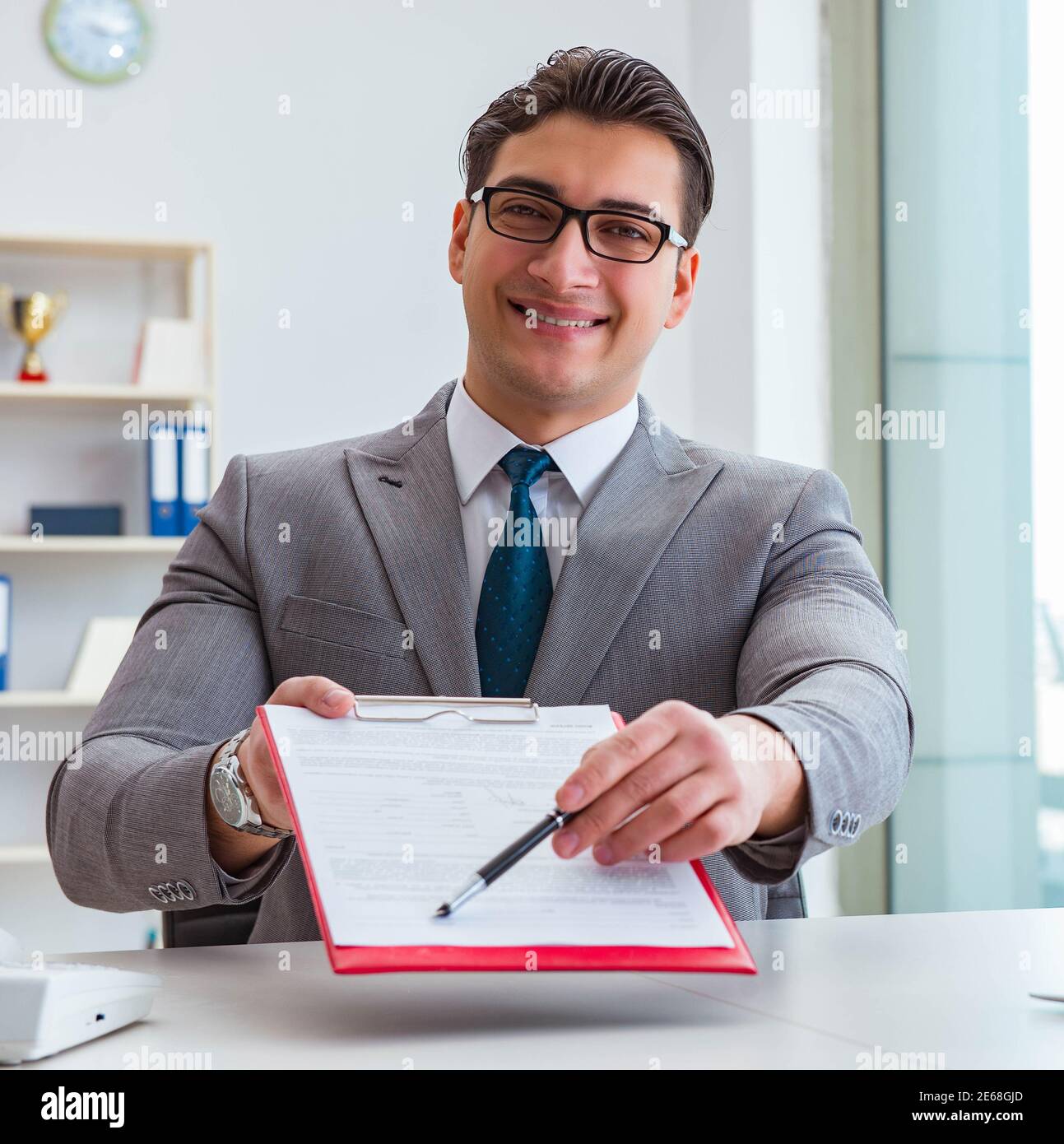 The businessman signing business documents in office Stock Photo - Alamy