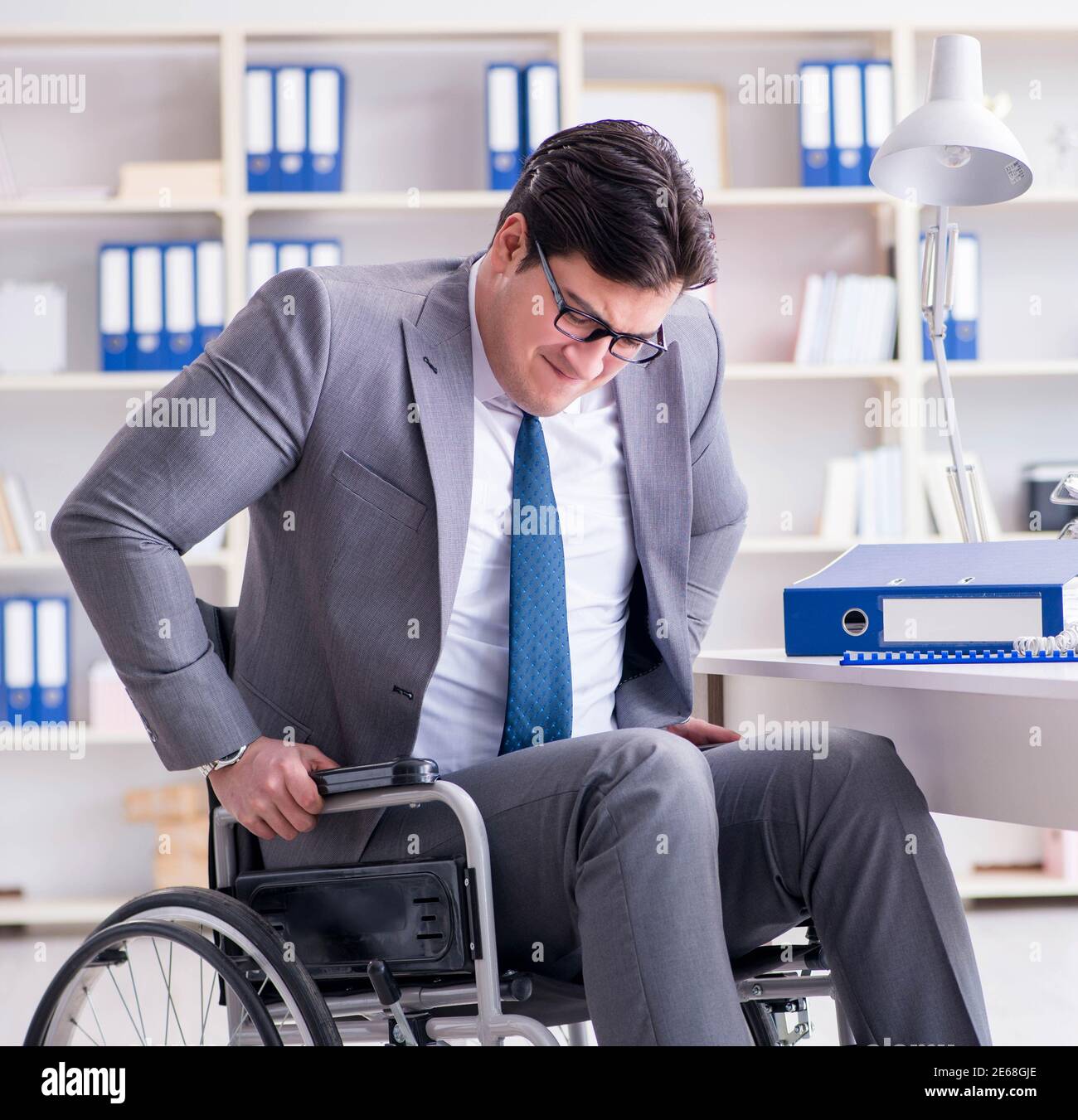 The disabled businessman working in the office Stock Photo - Alamy