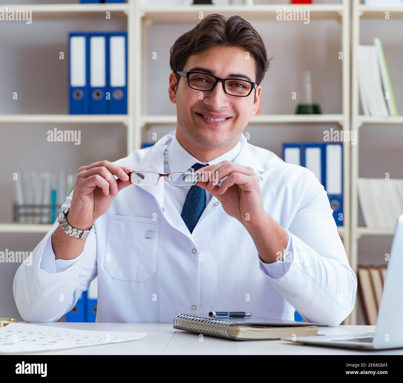 The doctor optician prescribing holding optical glasses Stock Photo - Alamy