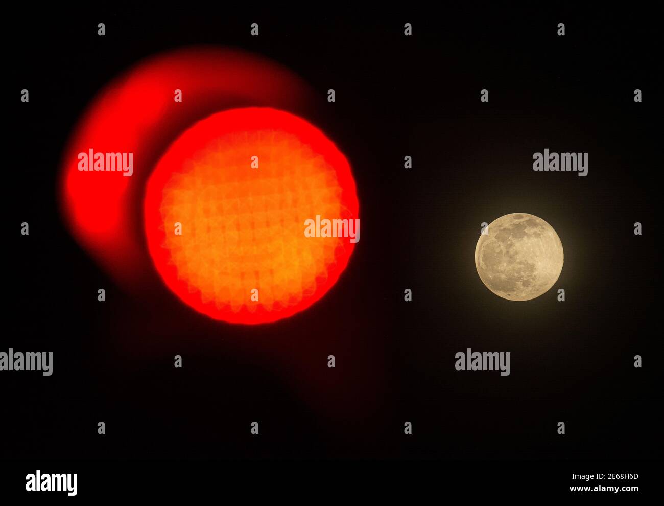The wolf moon seen from downtown city.During the first month of the ...