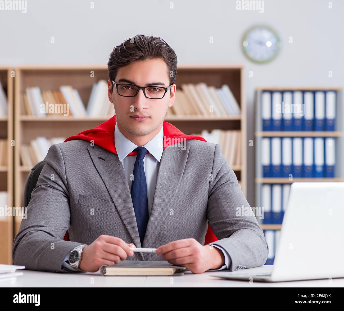 The superhero businessman working in the office Stock Photo - Alamy