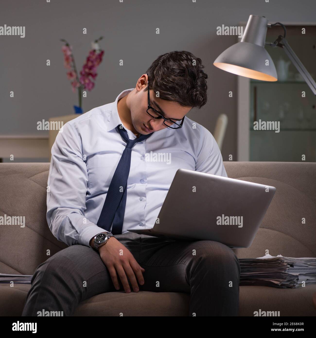 The businessman workaholic working late at home Stock Photo - Alamy