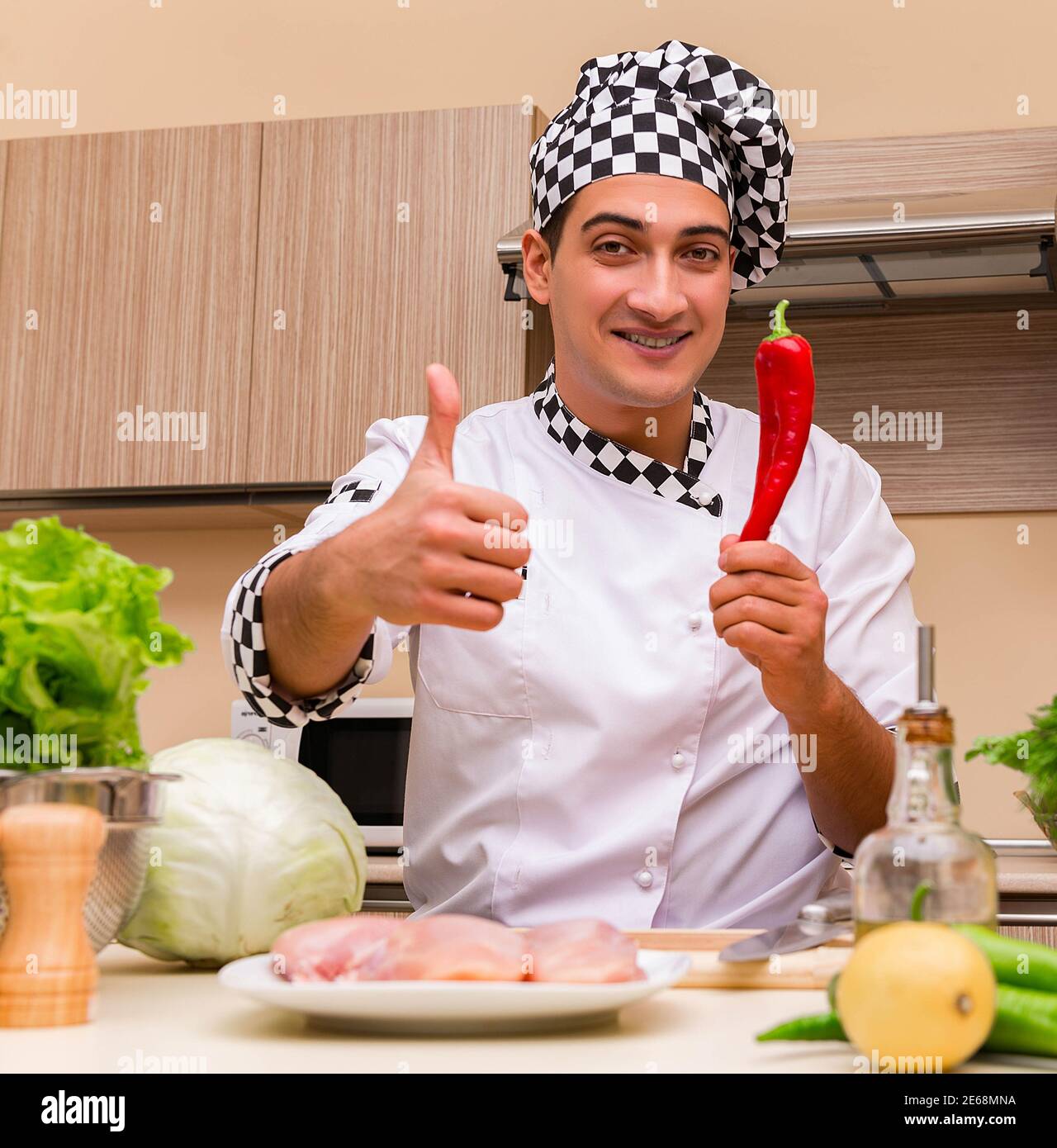 The young chef working in the kitchen Stock Photo - Alamy