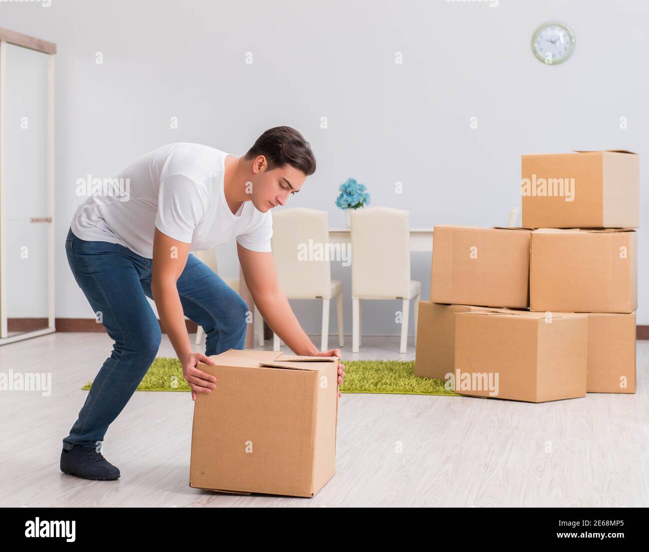 The man carrying boxes at home Stock Photo - Alamy
