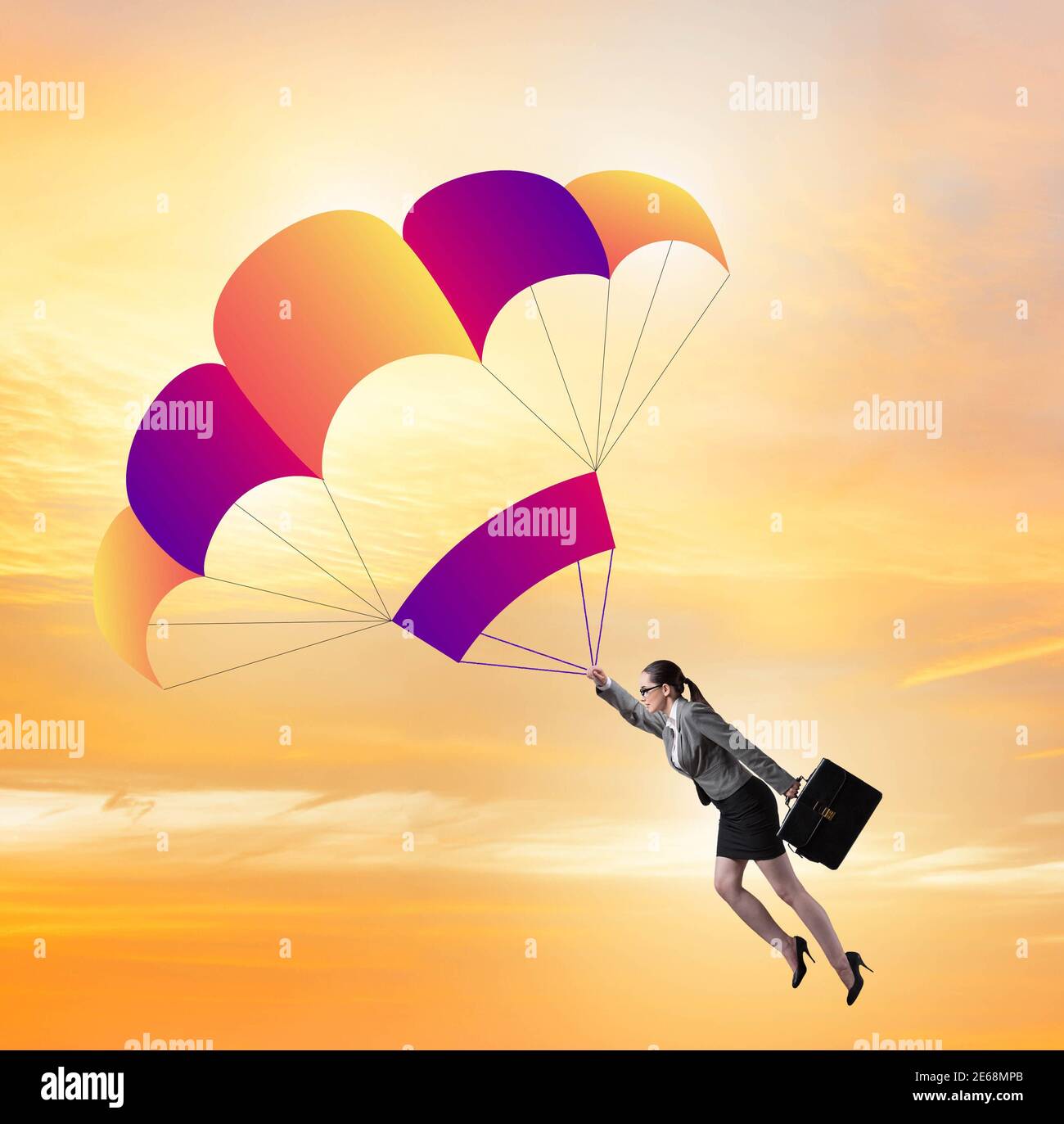 The businesswoman flying on parachute in business concept Stock Photo ...