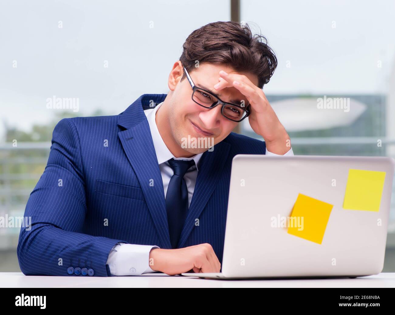 The workaholic businessman overworked with too much work in office ...