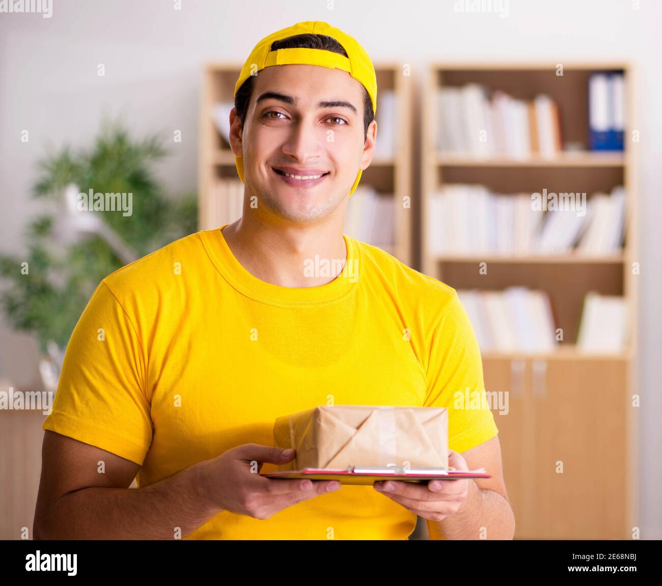 The delivery man delivering parcel box Stock Photo - Alamy