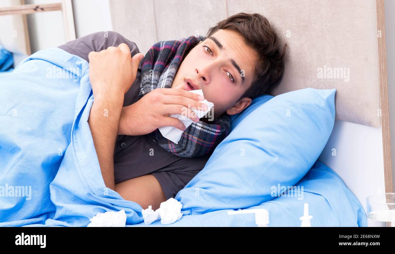 The sick man with flu lying in the bed Stock Photo - Alamy