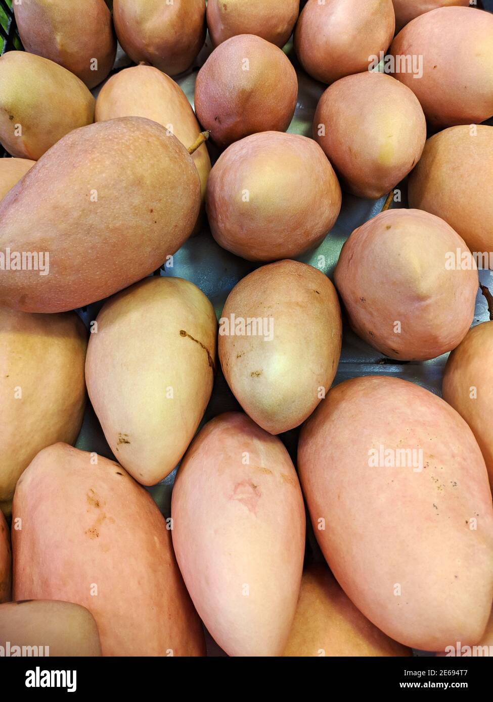 fresh light red mangoes on the stall for sale in the market Stock Photo ...