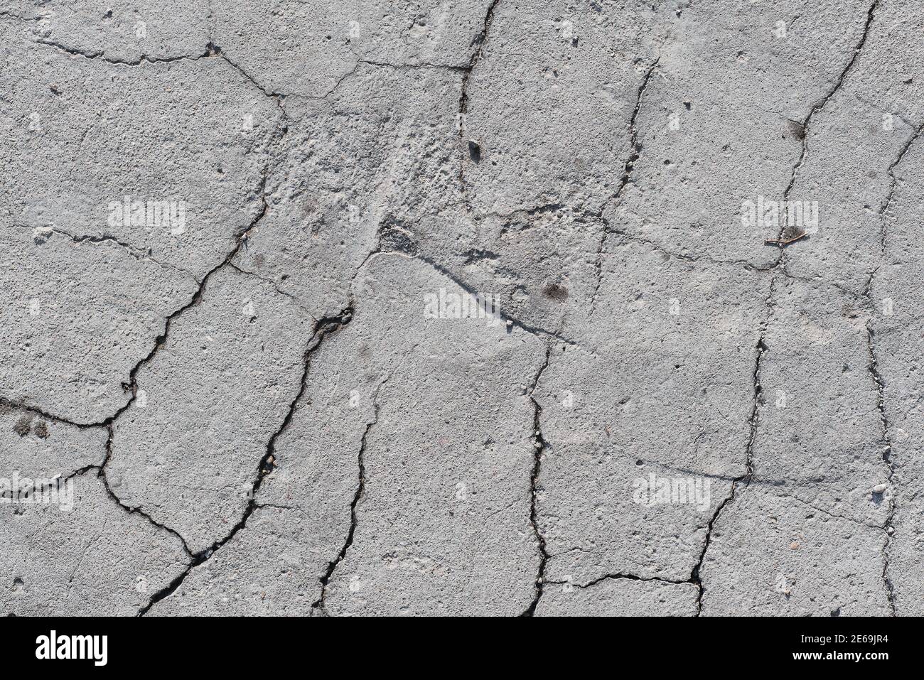 Grey texture of old broken asphalt road or wall big abrasions cracks on ...
