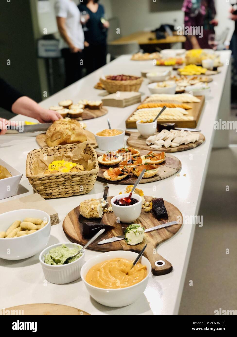 Vertical shot of a long table with many kinds of food placed on it ...