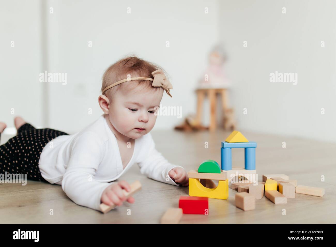 Little kid playing with colorful wooden building blocks. Blurred ...