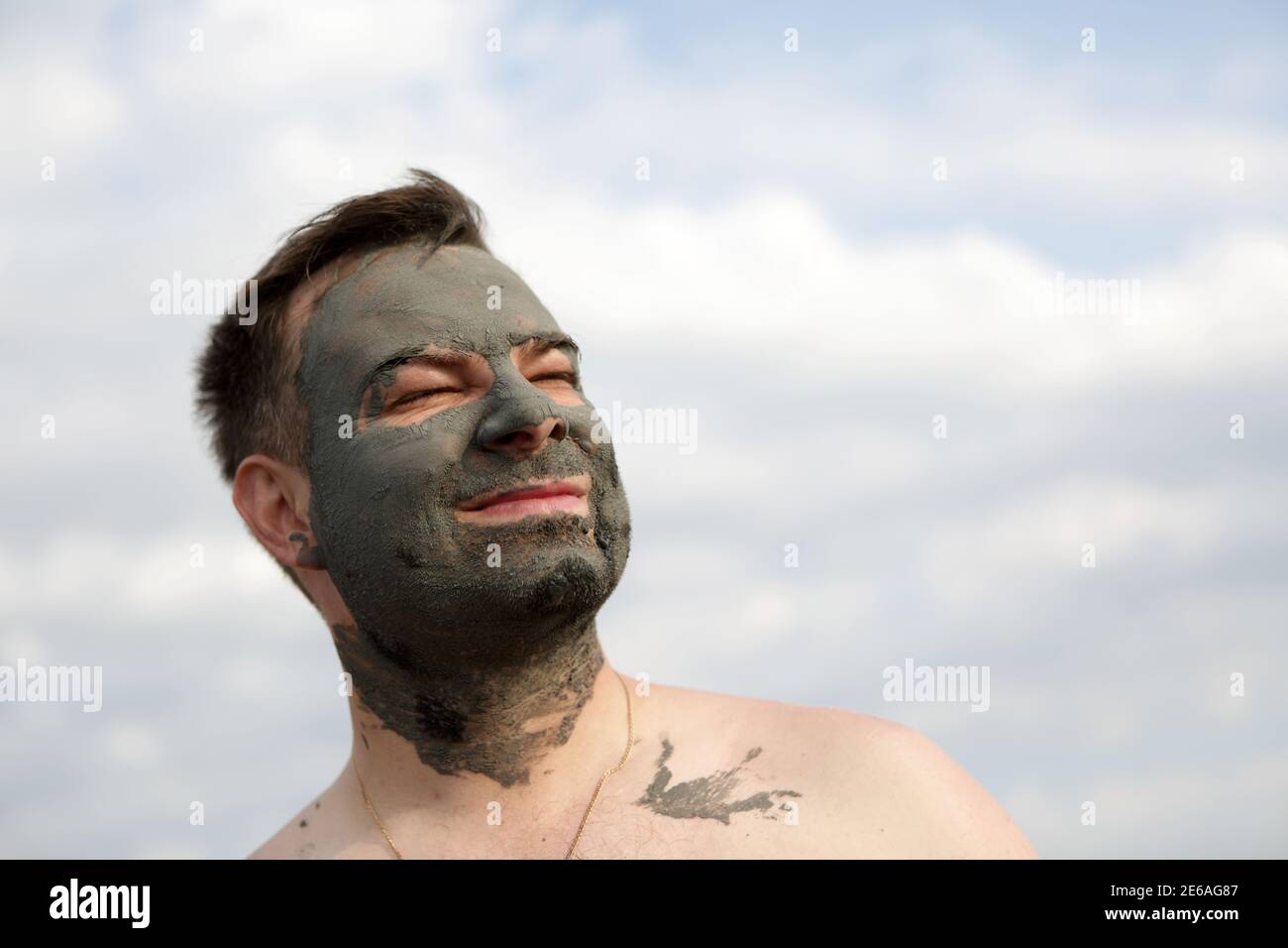 Man with black healthy mud on his face Stock Photo - Alamy