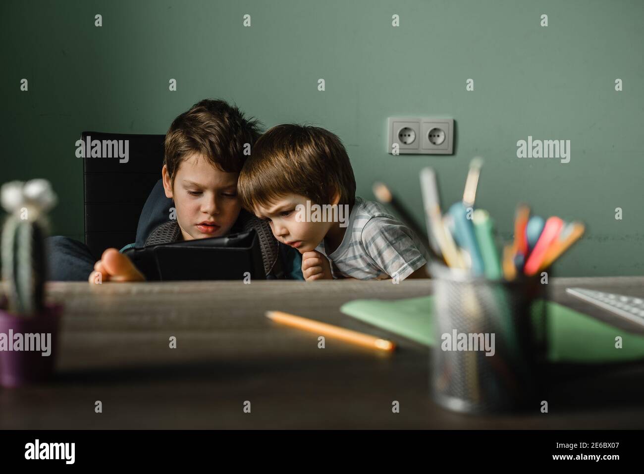 Children playing tablet at home, growing up with technology Stock Photo ...
