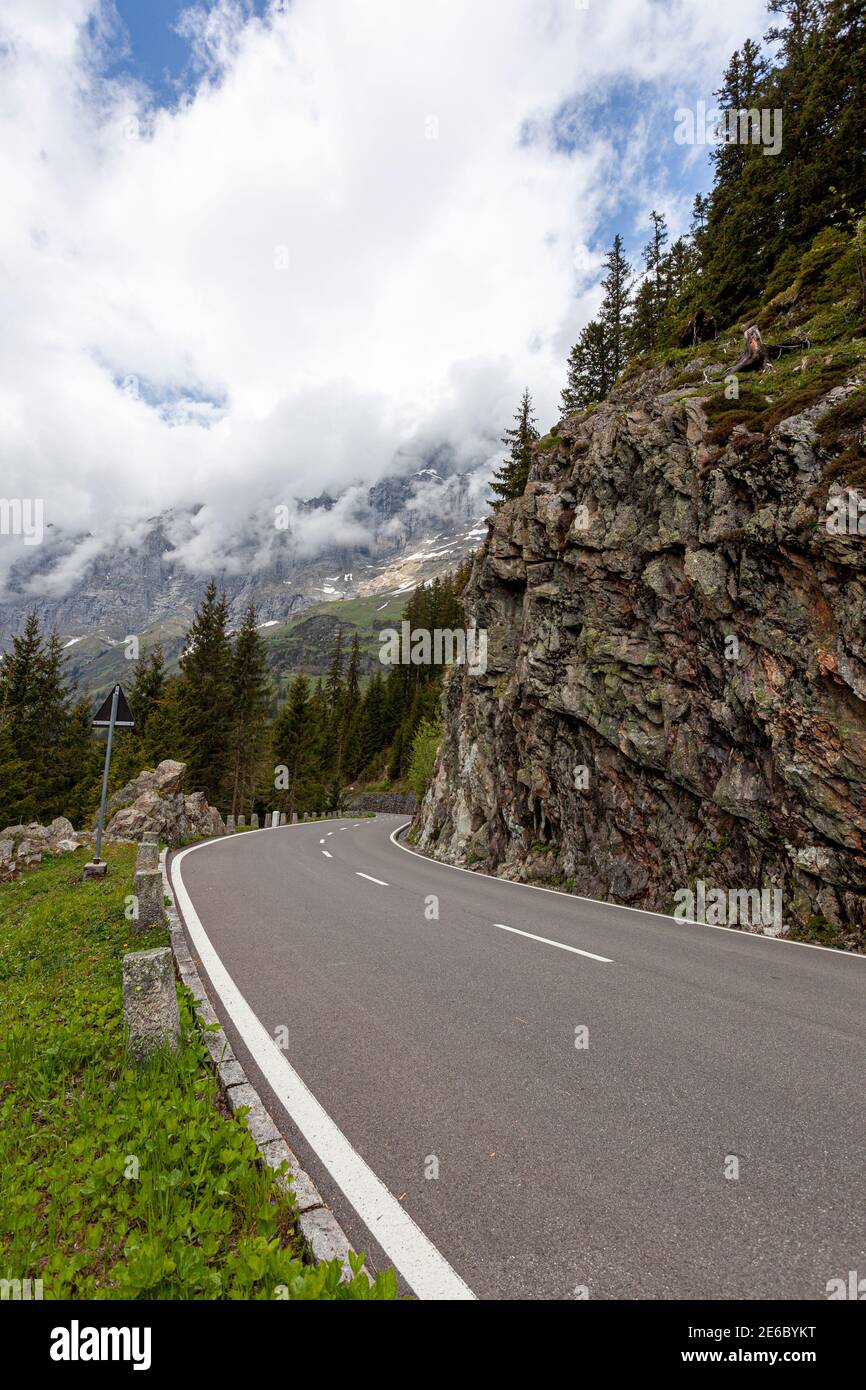 spring view of Swiss Alps at high elevation. Clouds move by the summits ...