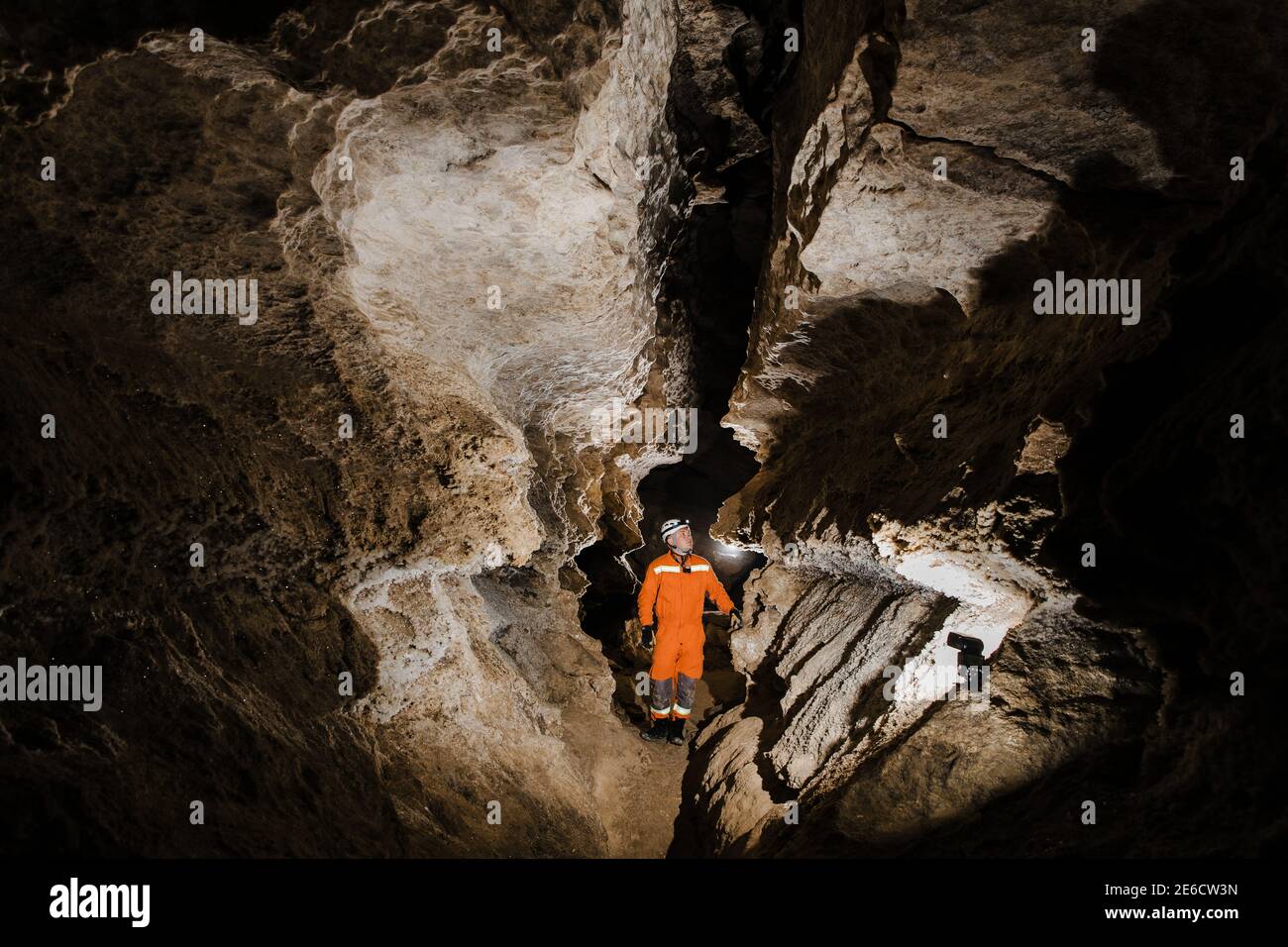 Speleologist descend by the rope in the deep vertical cave tunnel Stock ...