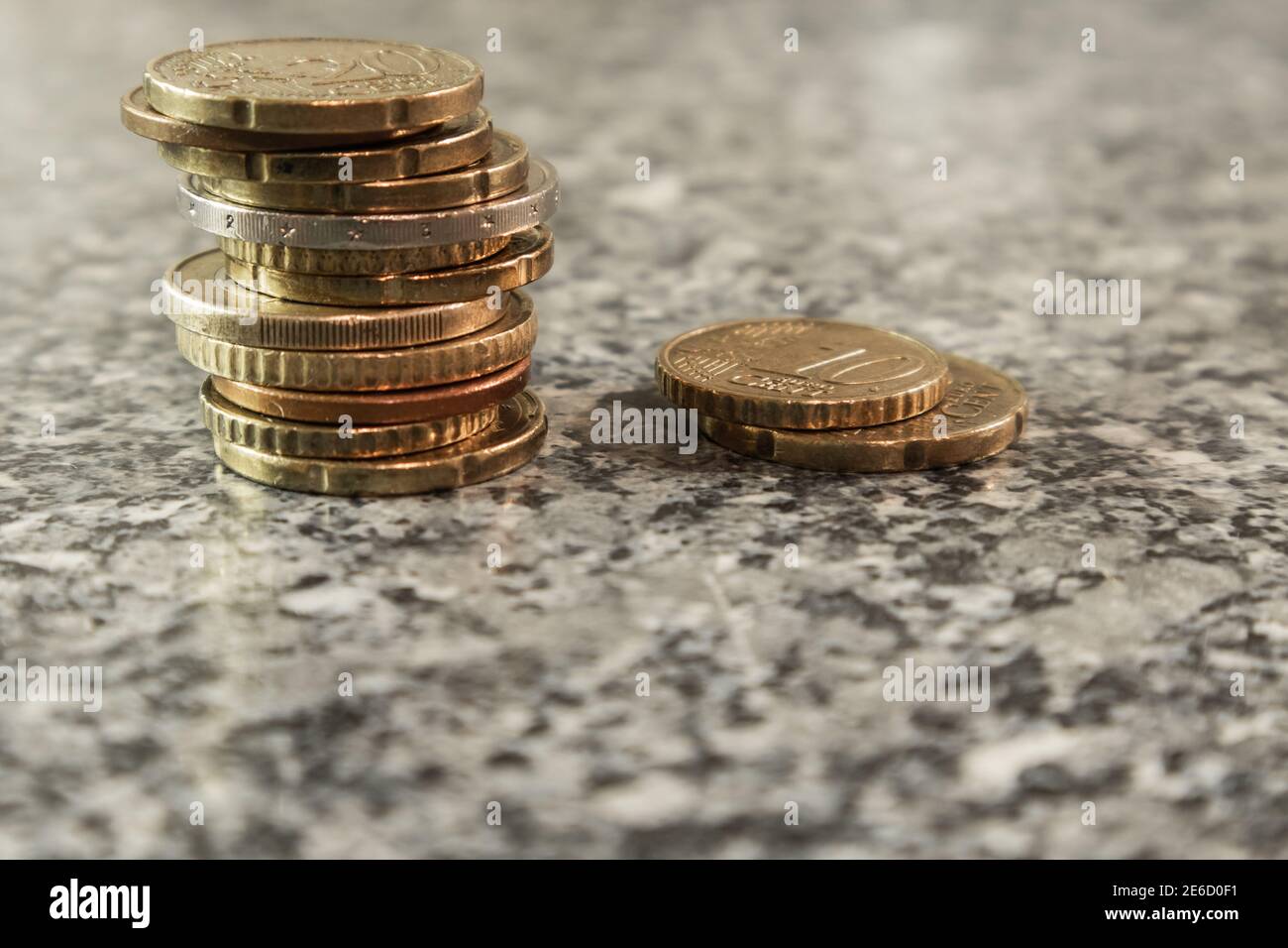Selective focus closeup of the stacked Euro coins on the granite ...