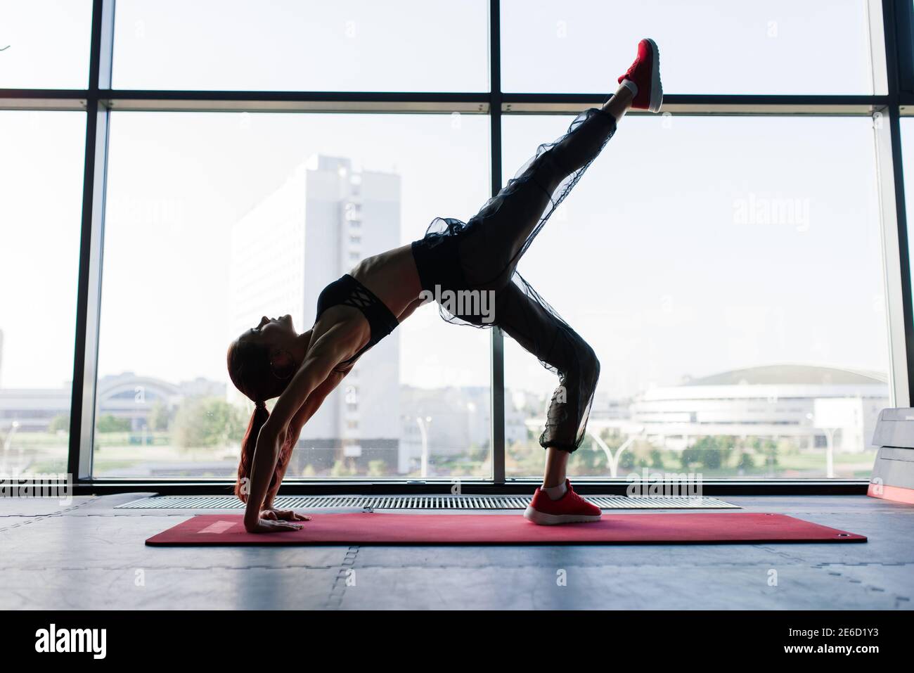 Shot of fitness woman on exercise mat. Female athlete lying on her back ...
