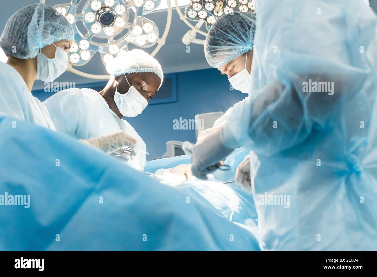 An international team of doctors performs a complex surgical operation ...